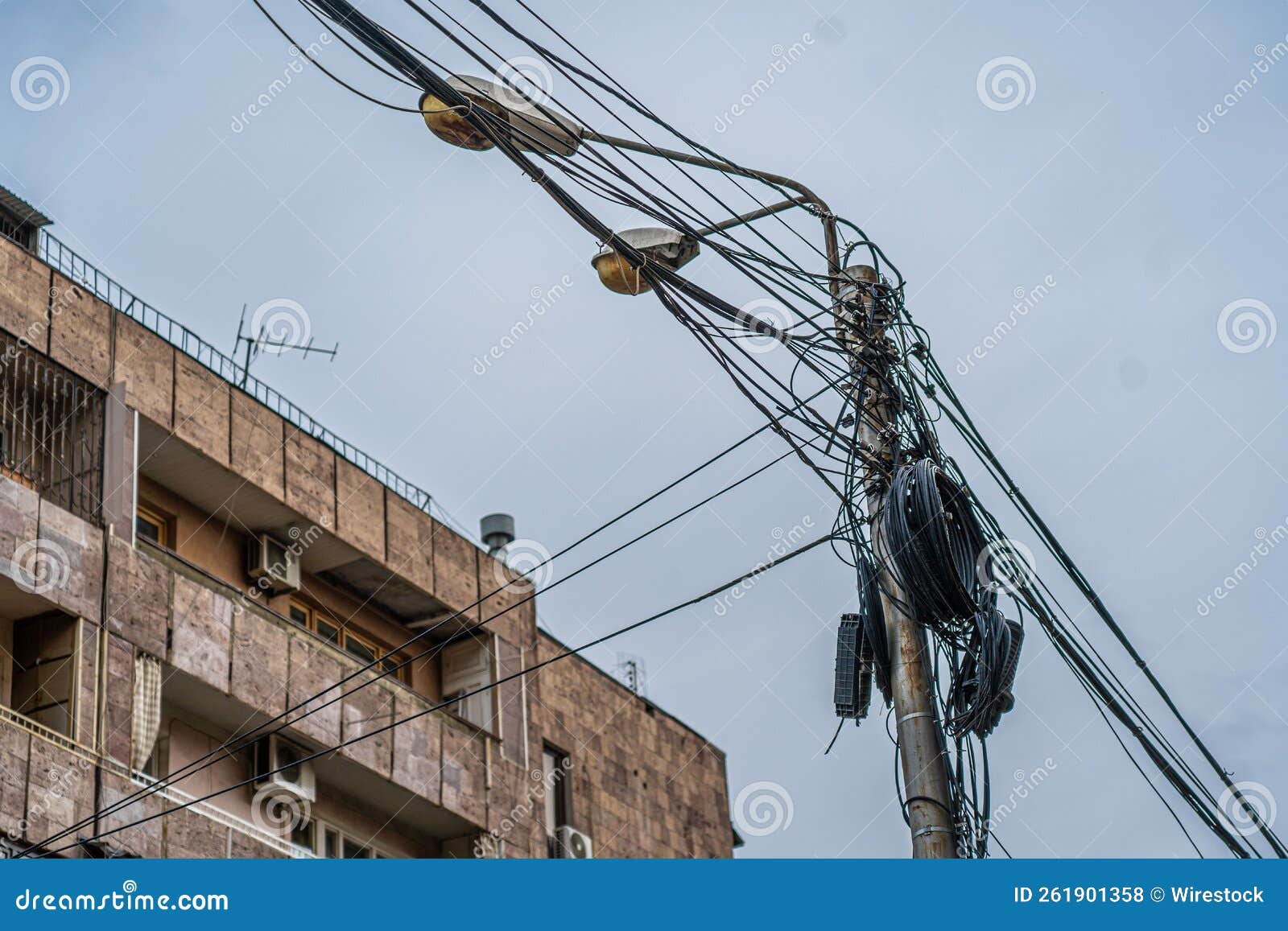 Low Angle of Electric Wires on Lamp Post in Front of Building Stock ...