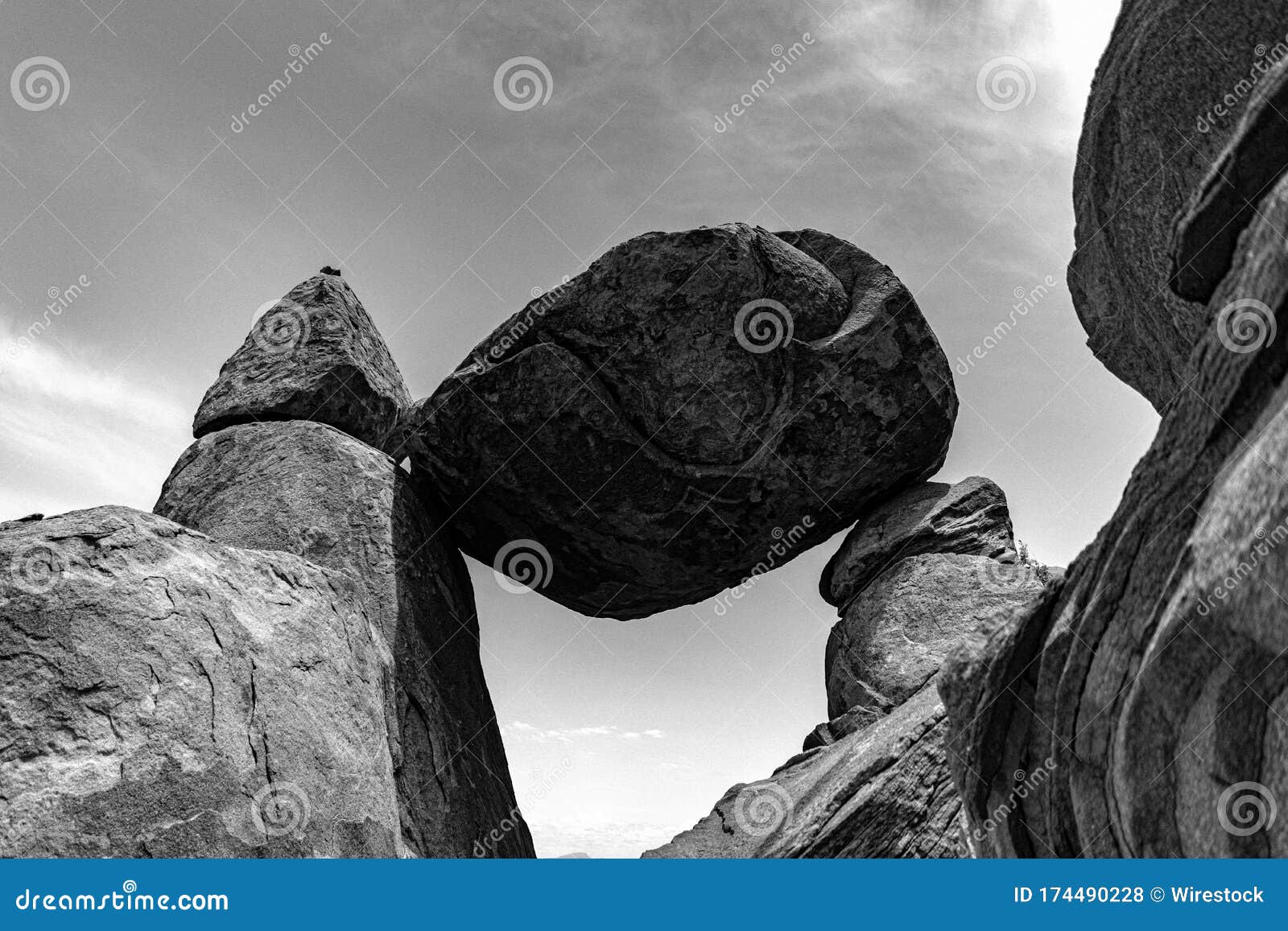 Low Angle Greyscale Shot of a Large Boulder Balanced on Rocks in ...