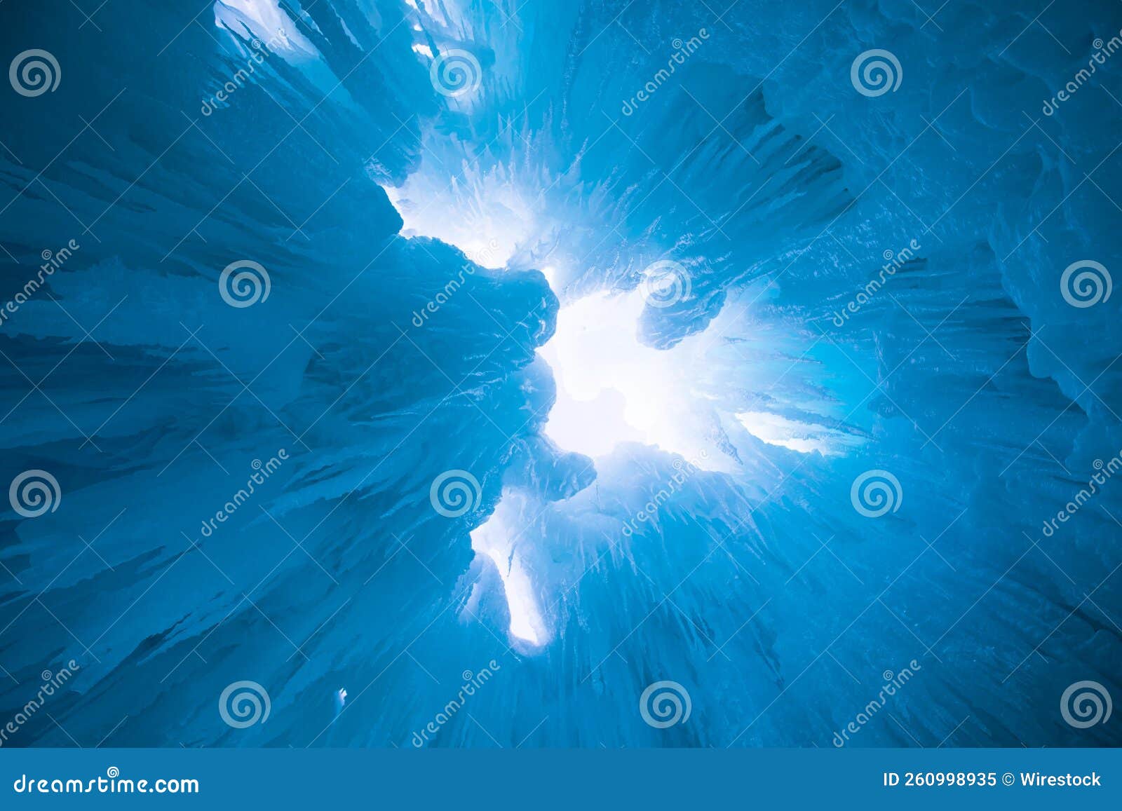 Low Angle of an Ice Formation with Huge Blue Icicles and Light Peeking ...
