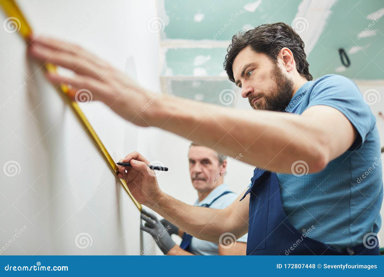 Construction Crew Measuring Wall Stock Photo - Image of enovating ...