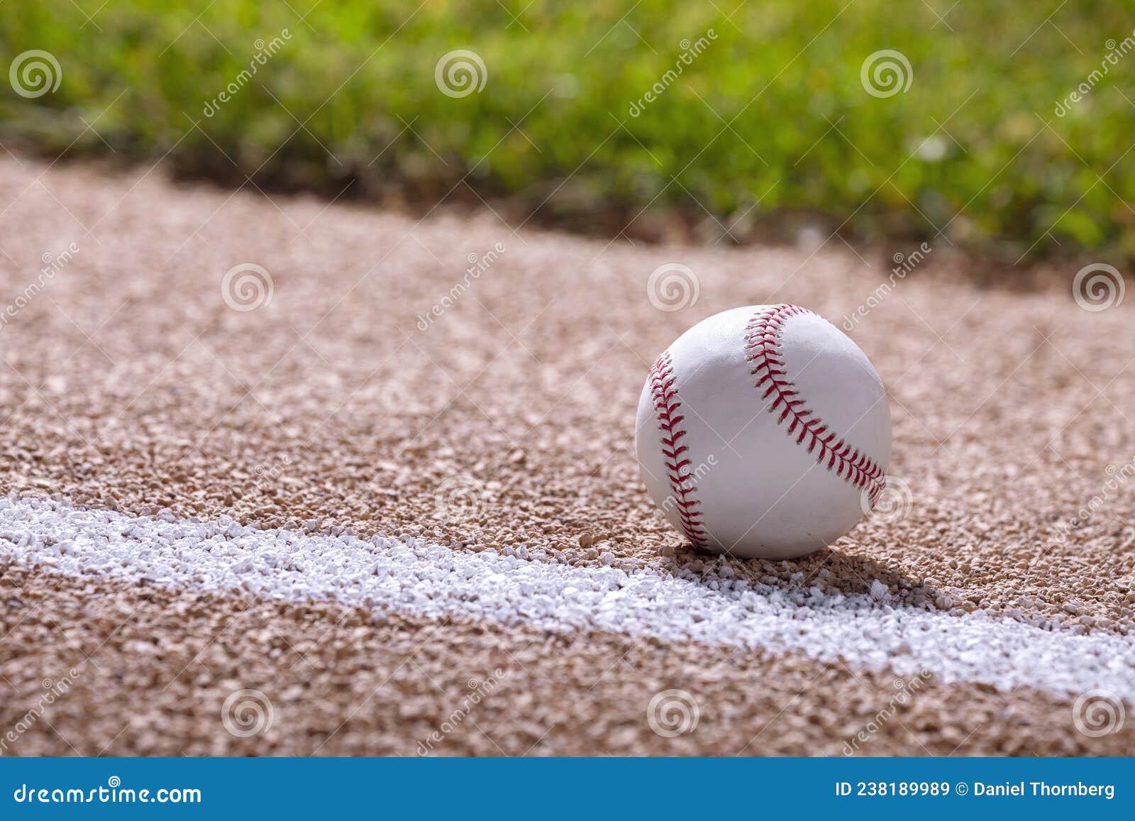 Low Angle Selective Focus View of a Baseball on a Basepath in Sunlight ...