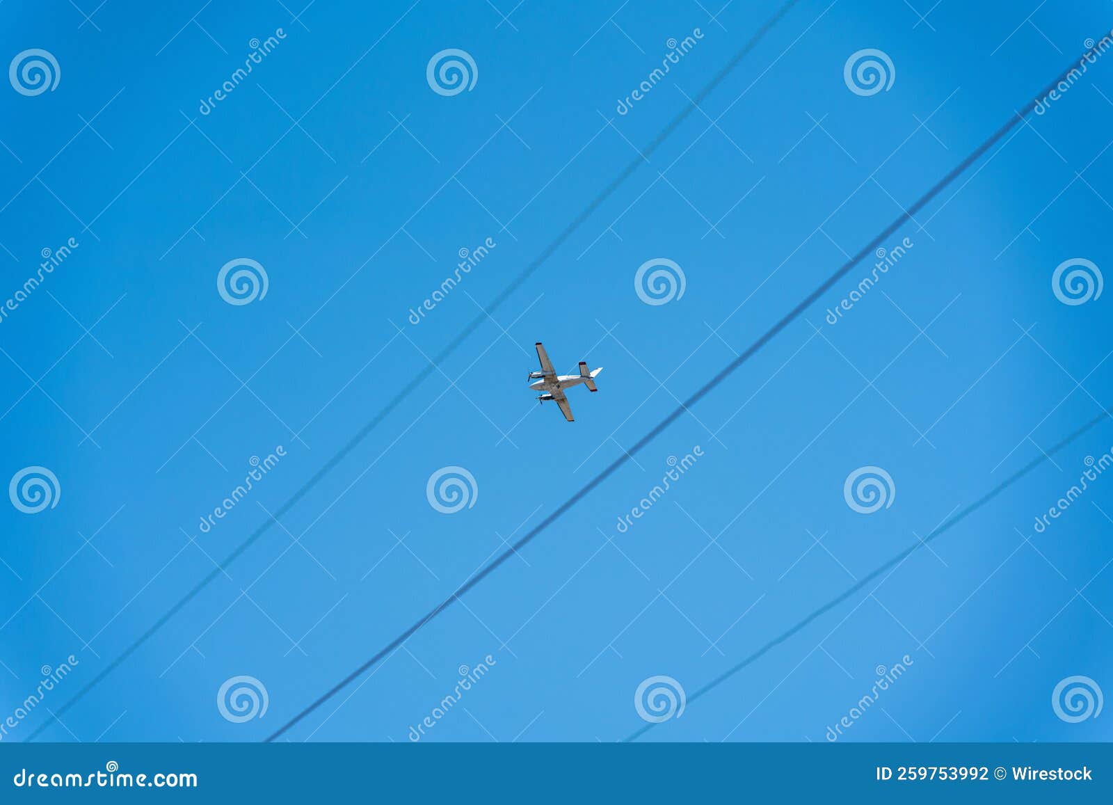 Low-angle Shot of the Airplane Flying in the Sky with Power Lines ...