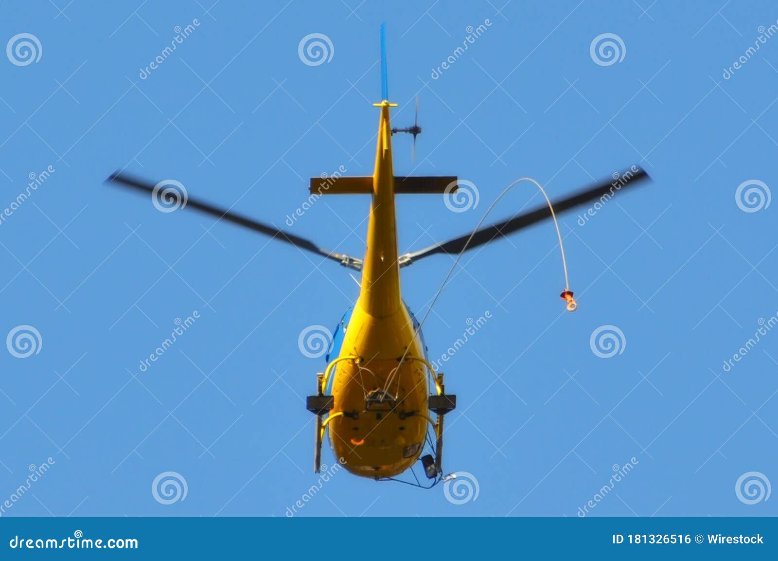 Low Angle Shot of a Bright Yellow Helicopter on a Clean Blue Sky ...