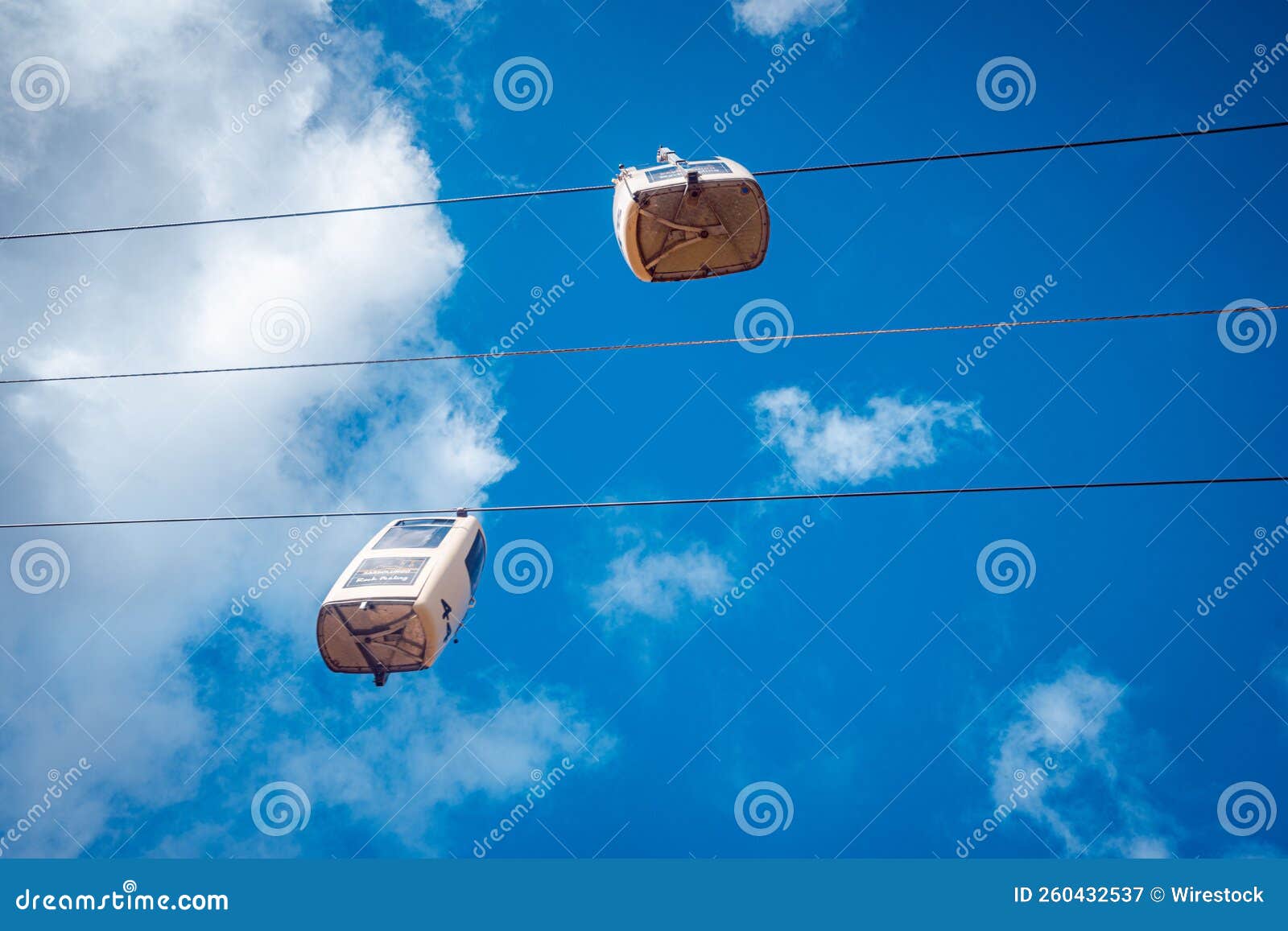 Low-angle Shot of Cableway Cabins with a Blue Cloudy Sky in the ...