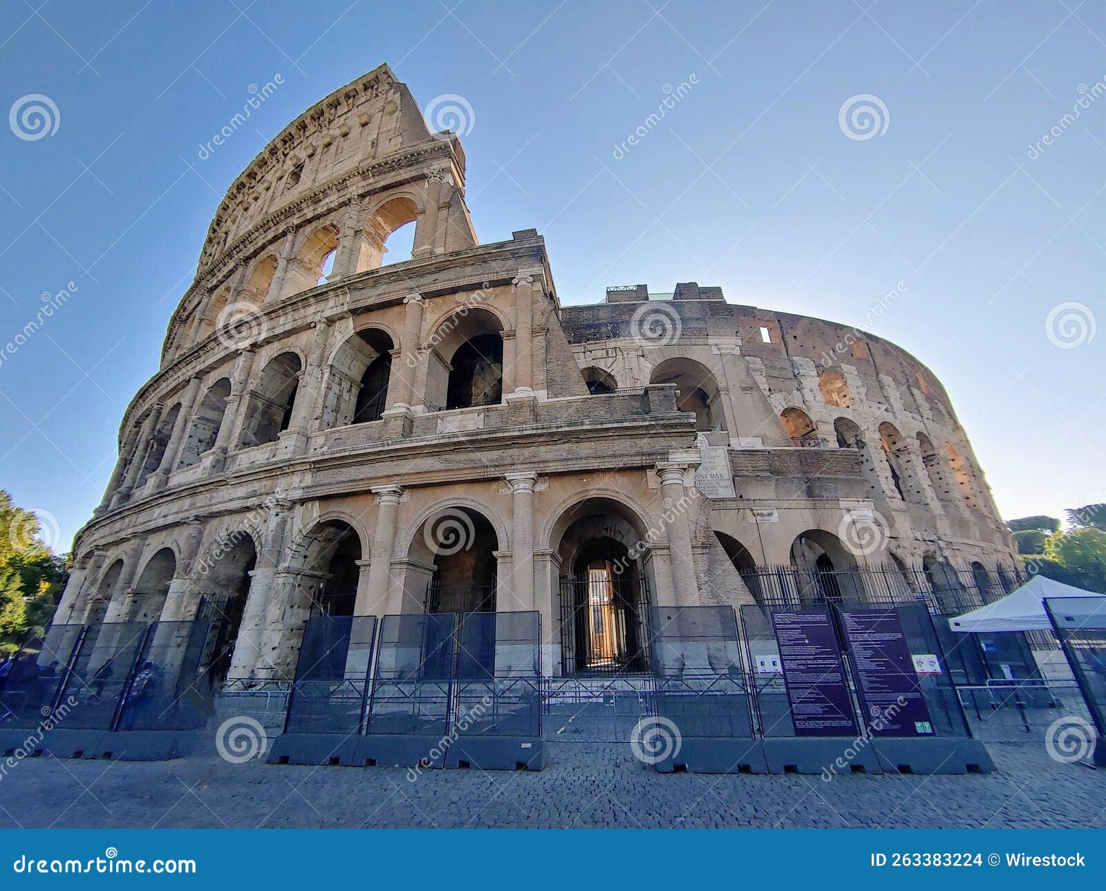 Low Angle Shot of a Coliseum Building with Blue Sky in the Background ...