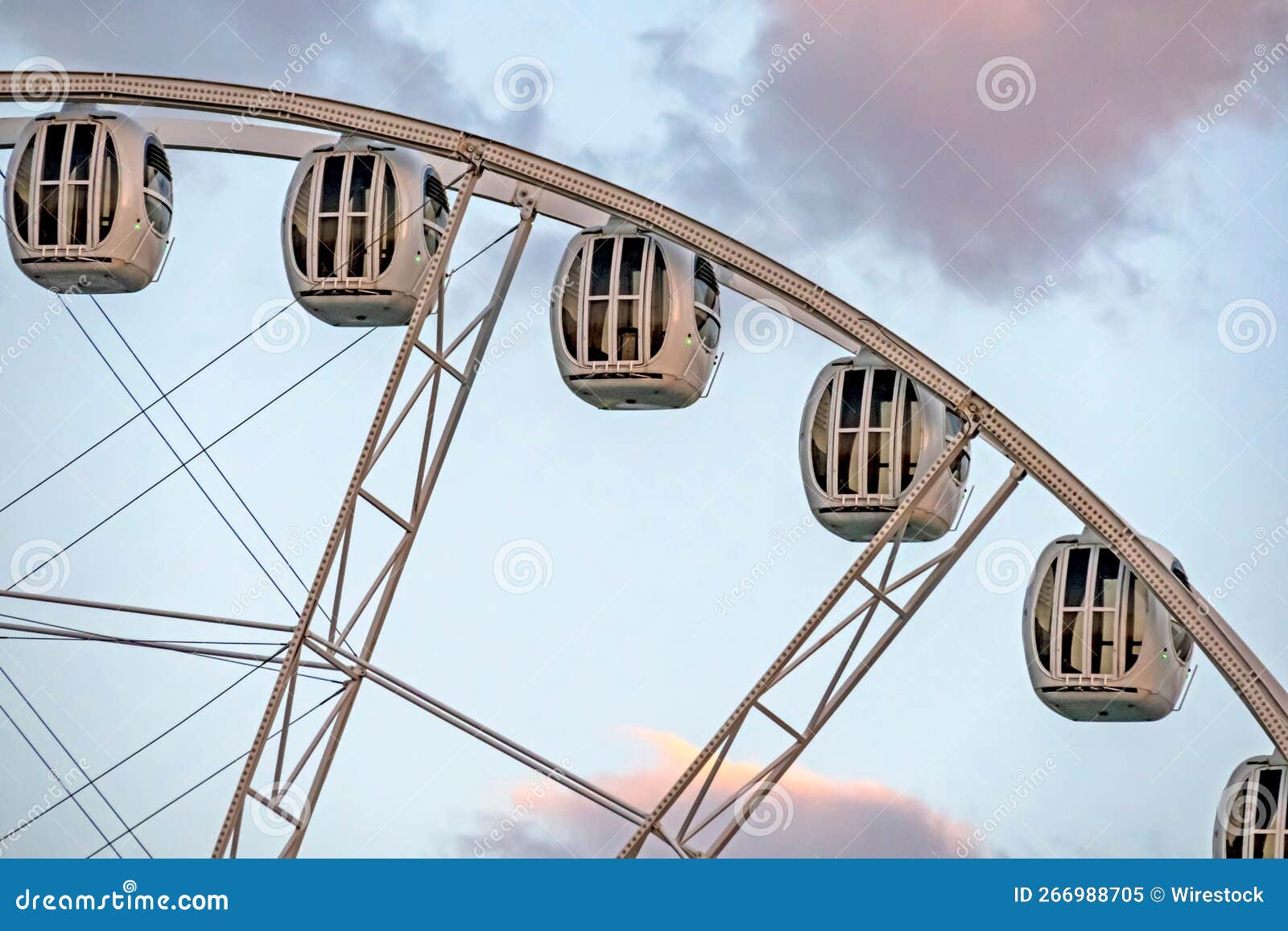Low Angle Shot Of Ferris Wheel With Cabins In Amusement Park Under