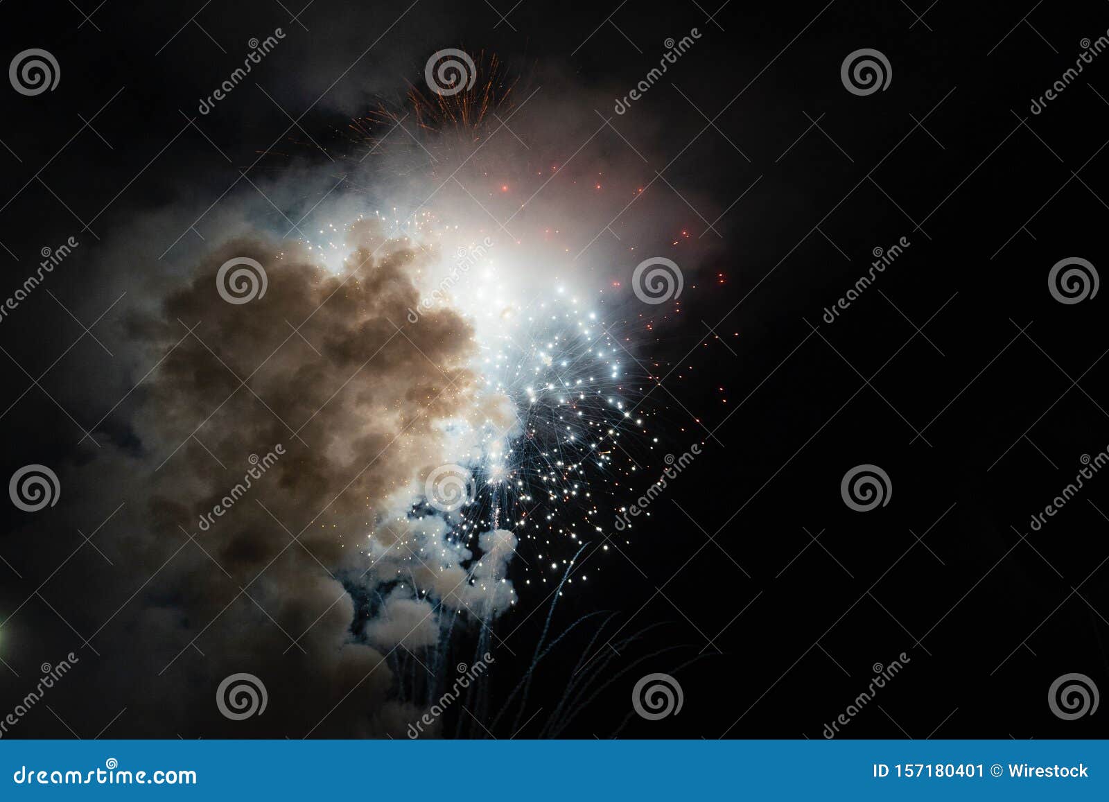 Low Angle Shot of Fireworks Behind the Cloud with a Dark Background ...