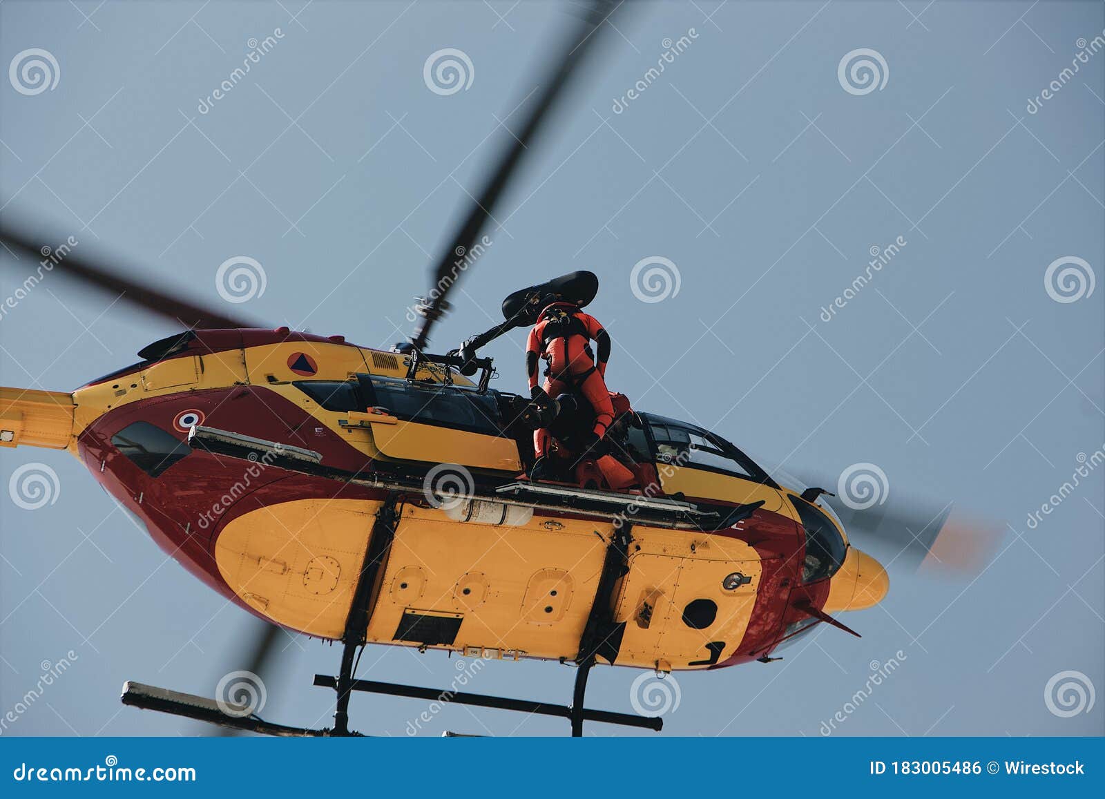 Low Angle Shot of a Helicopter Under a Clear Blue Sky Stock Photo ...