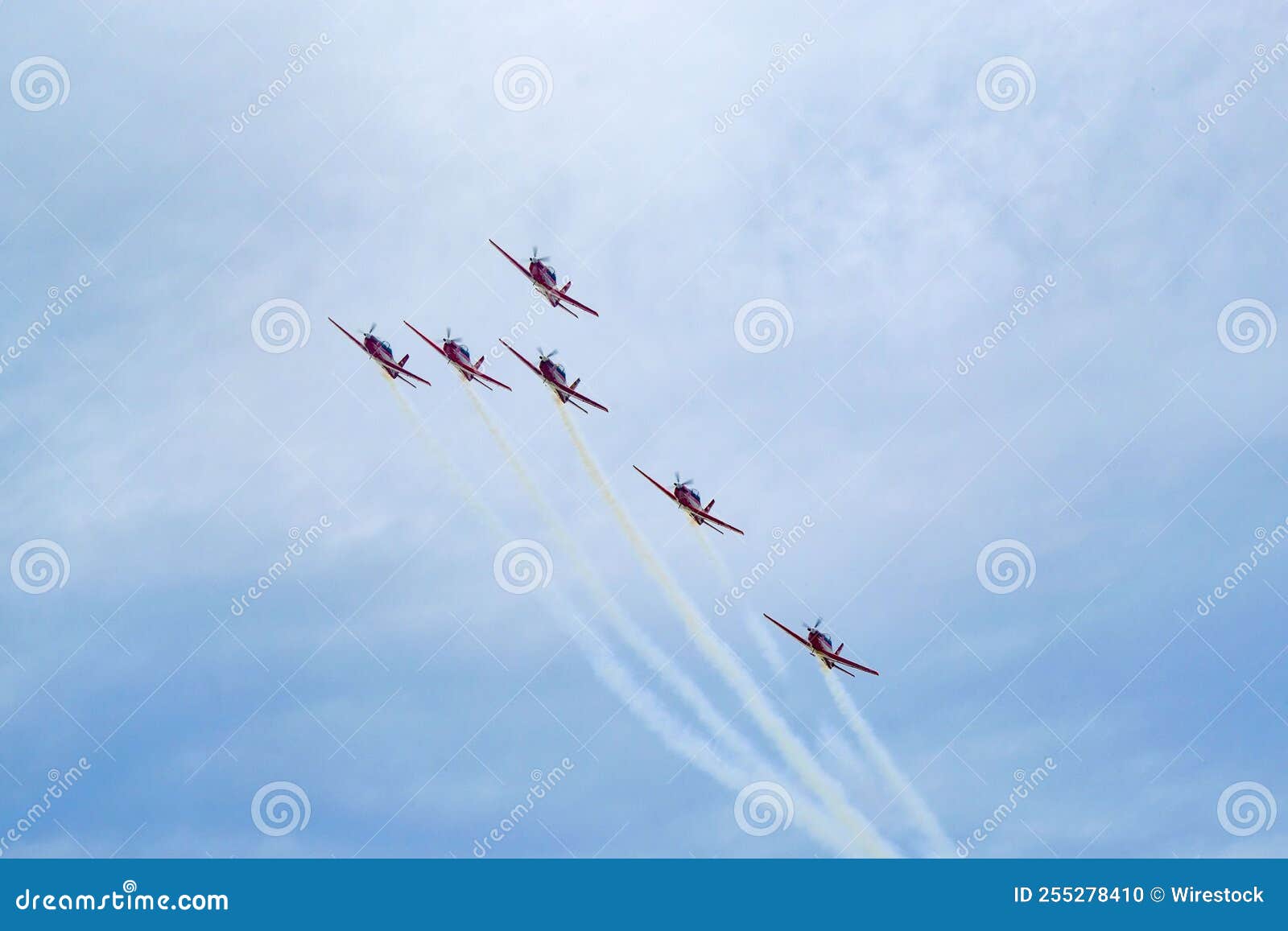 Low Angle Shot of Jet Team Performance in the Blue Cloudy Sky Stock ...