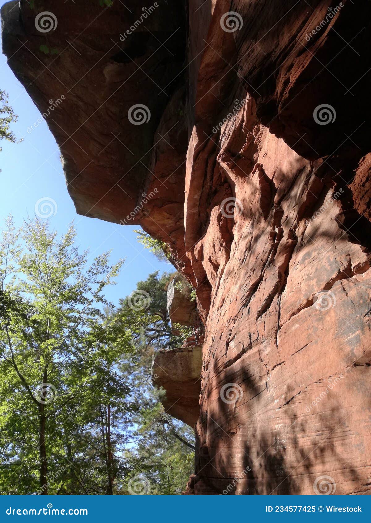 Low Angle Shot of a Large Red Rock Cliff Stock Image - Image of large ...