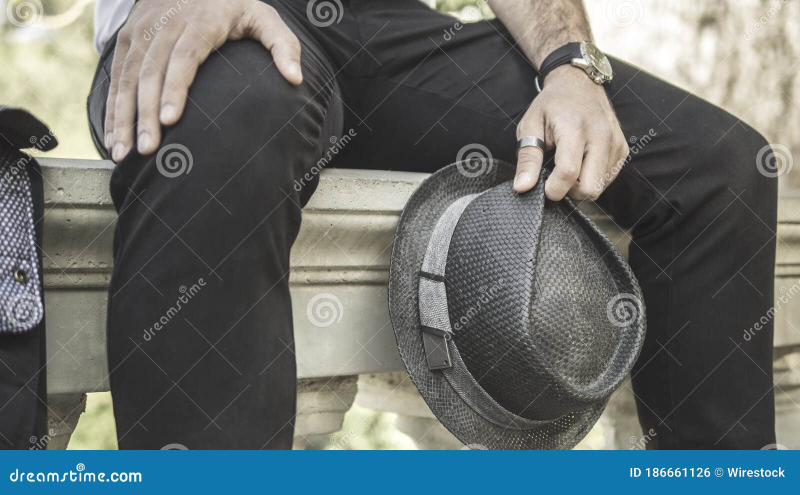 Low Angle Shot of a Male Holding a Fedora Hat while Sitting on the ...