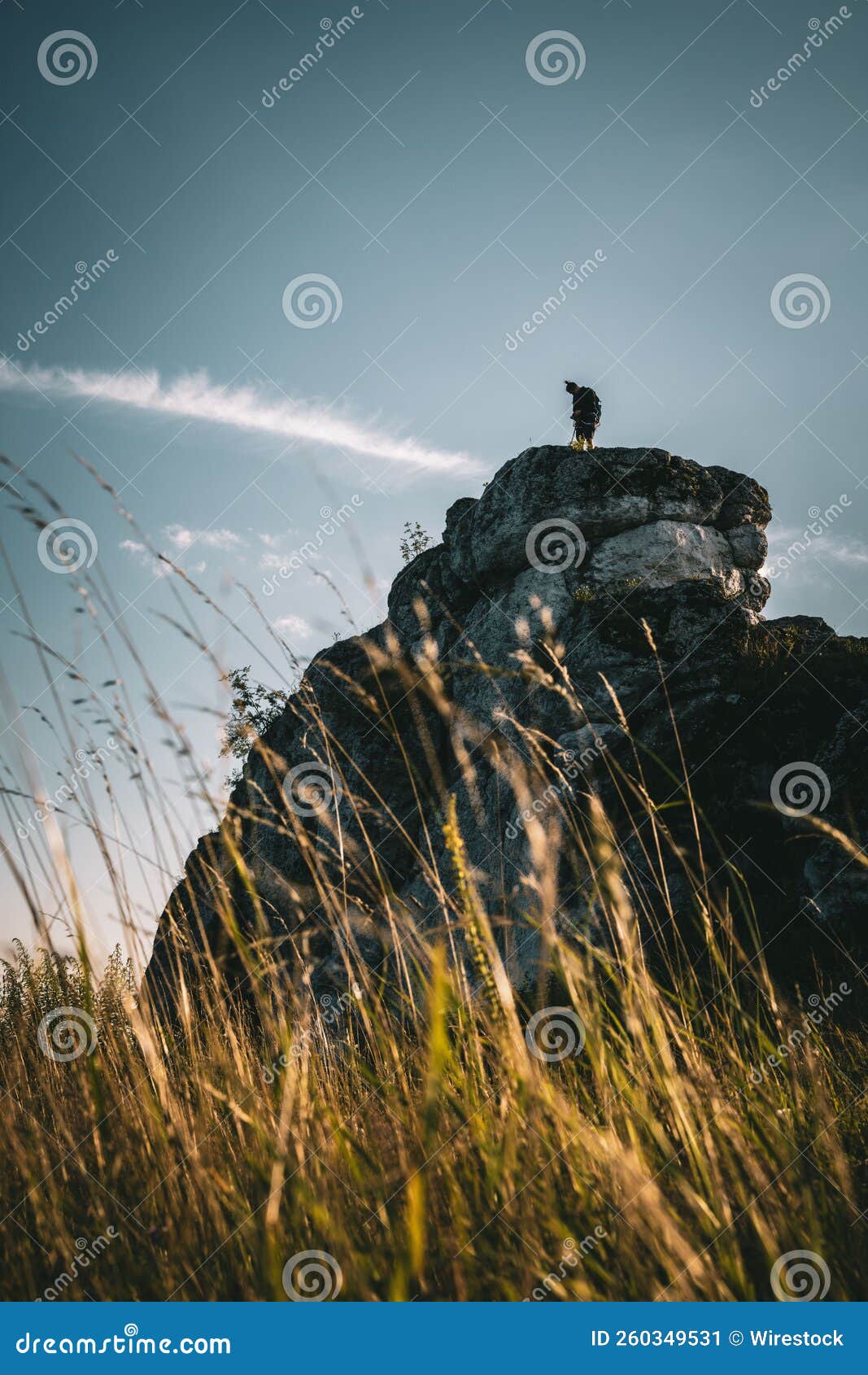 Low-angle Shot of a Man Standing at the Top of a Huge Cliff Stock Image ...