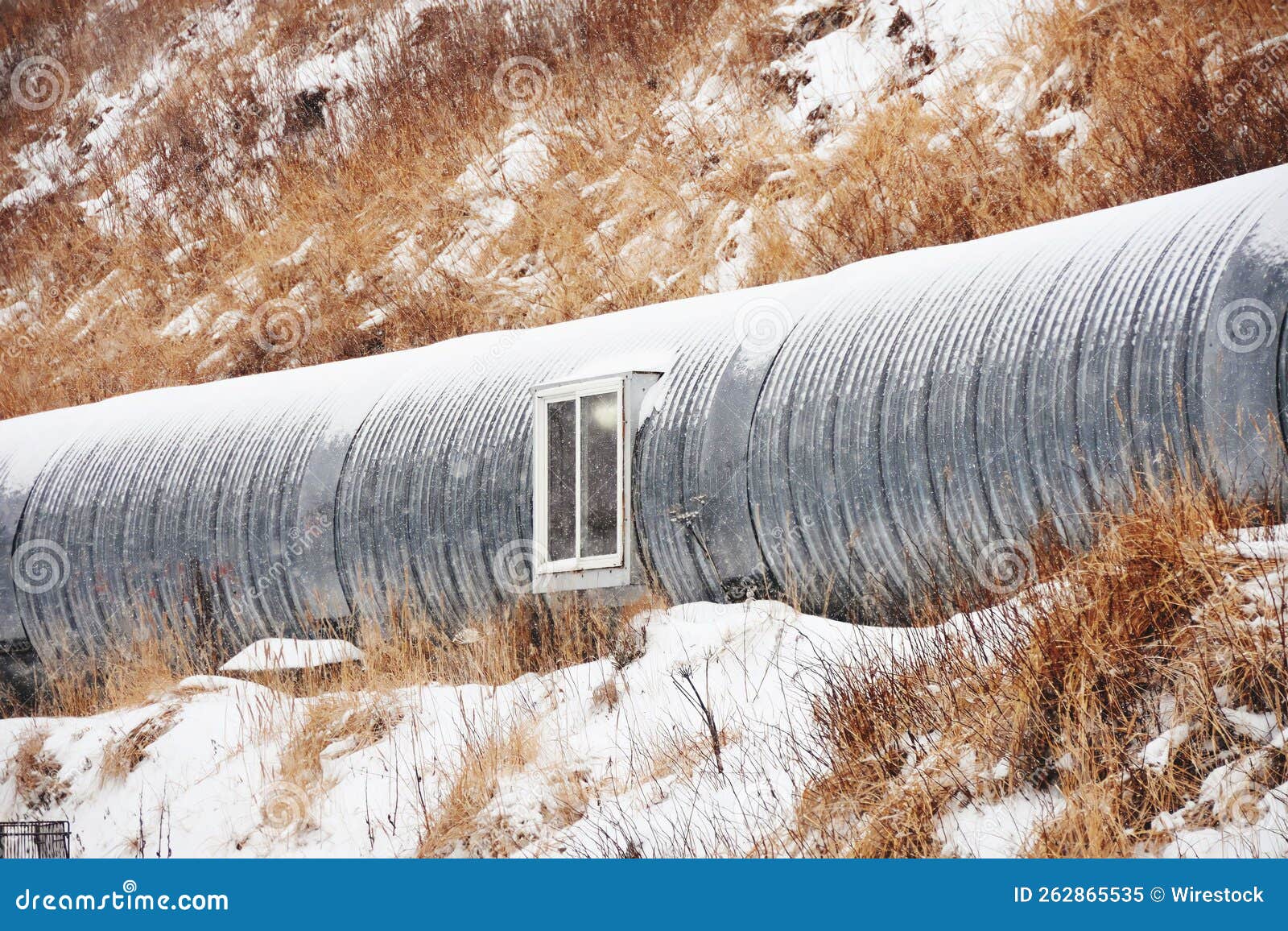 Low Angle Shot of a Metal Tunnel with a Window on it, on an Ice-covered ...