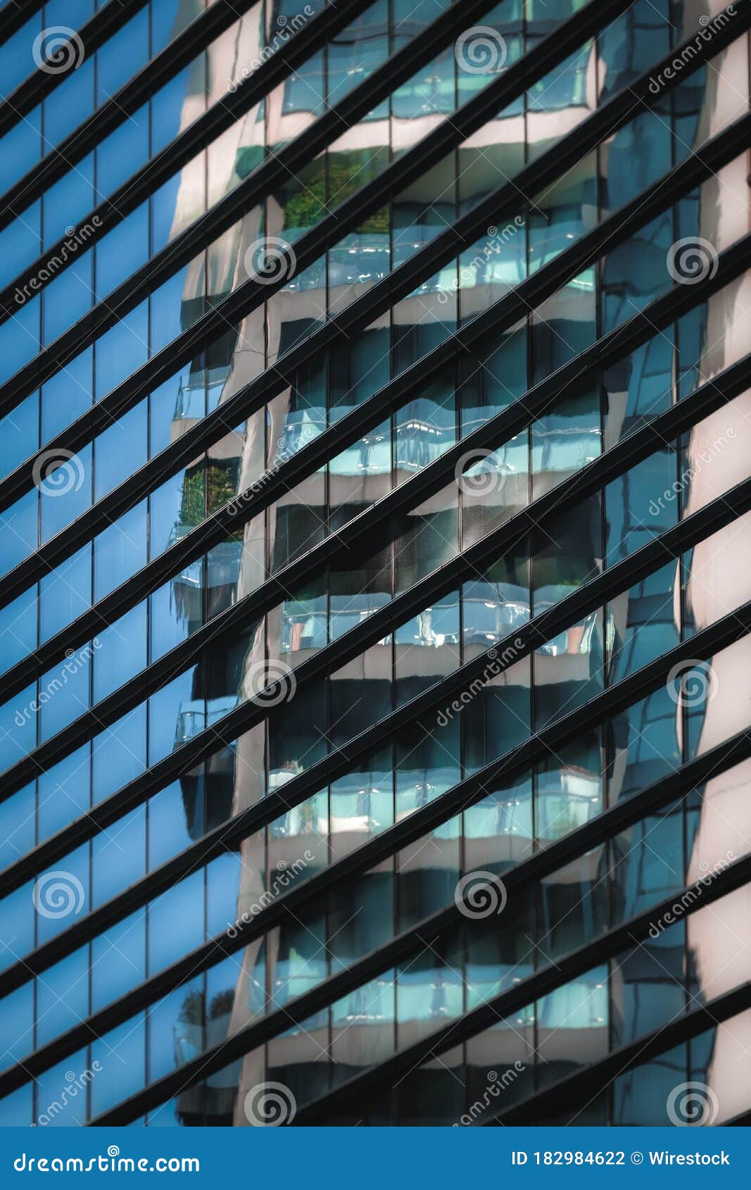 Low Angle Shot of a Modern Building Glass Facade with a Reflection ...