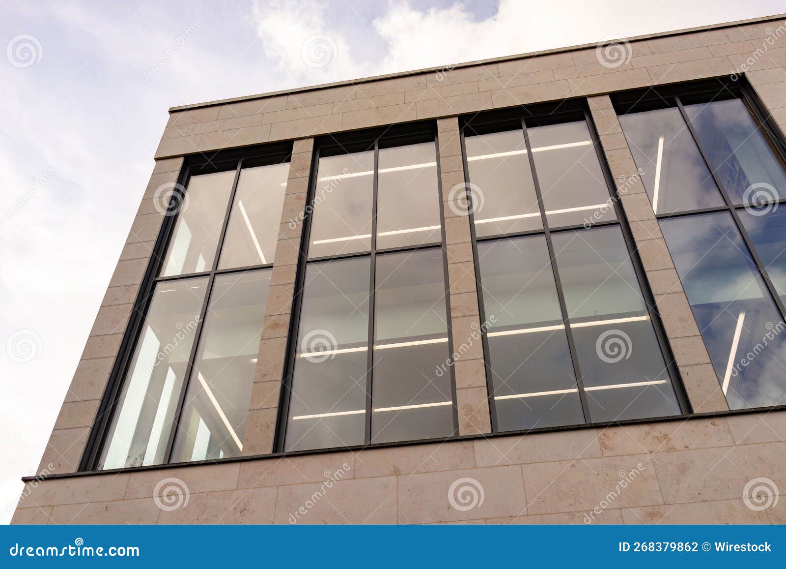 Low Angle Shot of a Modern Building with Large Windows and the Clouds ...