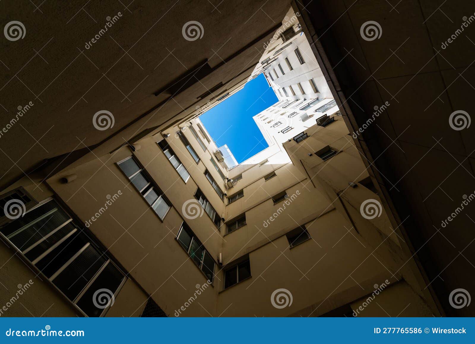 Low-angle Shot of the Narrow Square-shaped Space between a Building ...