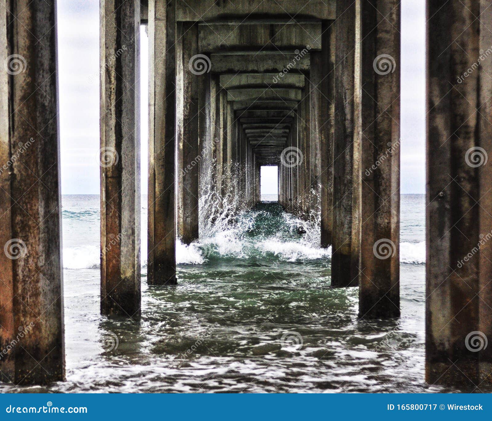 Low Angle Shot of Ocean Waves Splashing To the Bridge Columns Stock ...