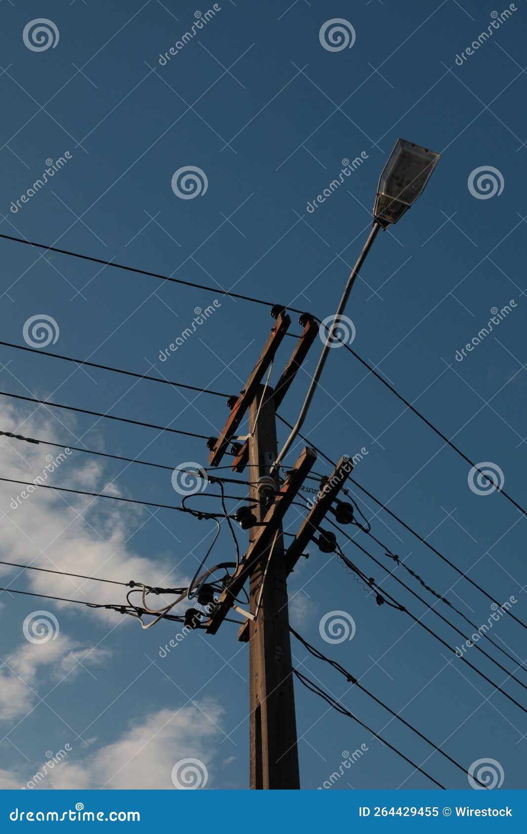 Low-angle Shot of Power Poles with Wires Against the Blue Sky Stock ...
