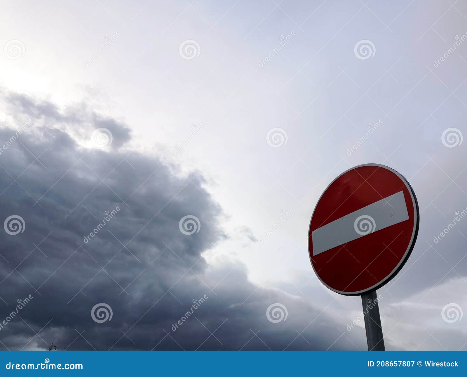 Low Angle Shot of a Round Stop Sign Under a Gray Cloudy Sky Stock Image ...
