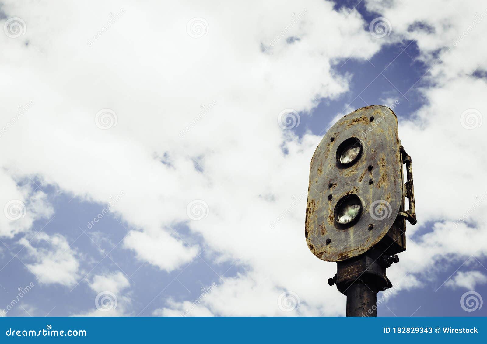 Low Angle Shot of a Rusty Train Traffic Light Under a Blue Cloudy Sky ...