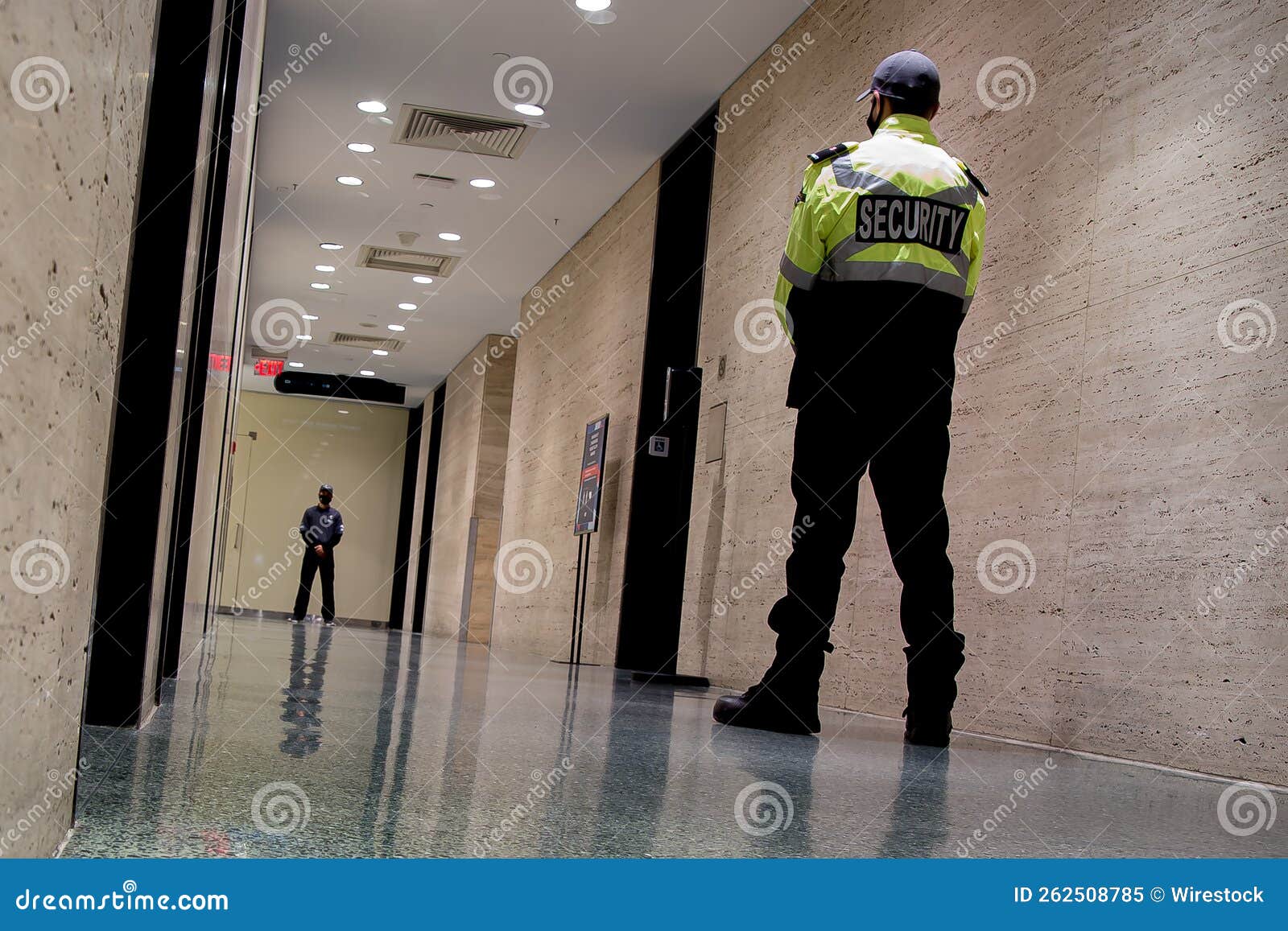 Low Angle Shot of Security Guards Patrolling Inside Commercial B Stock ...