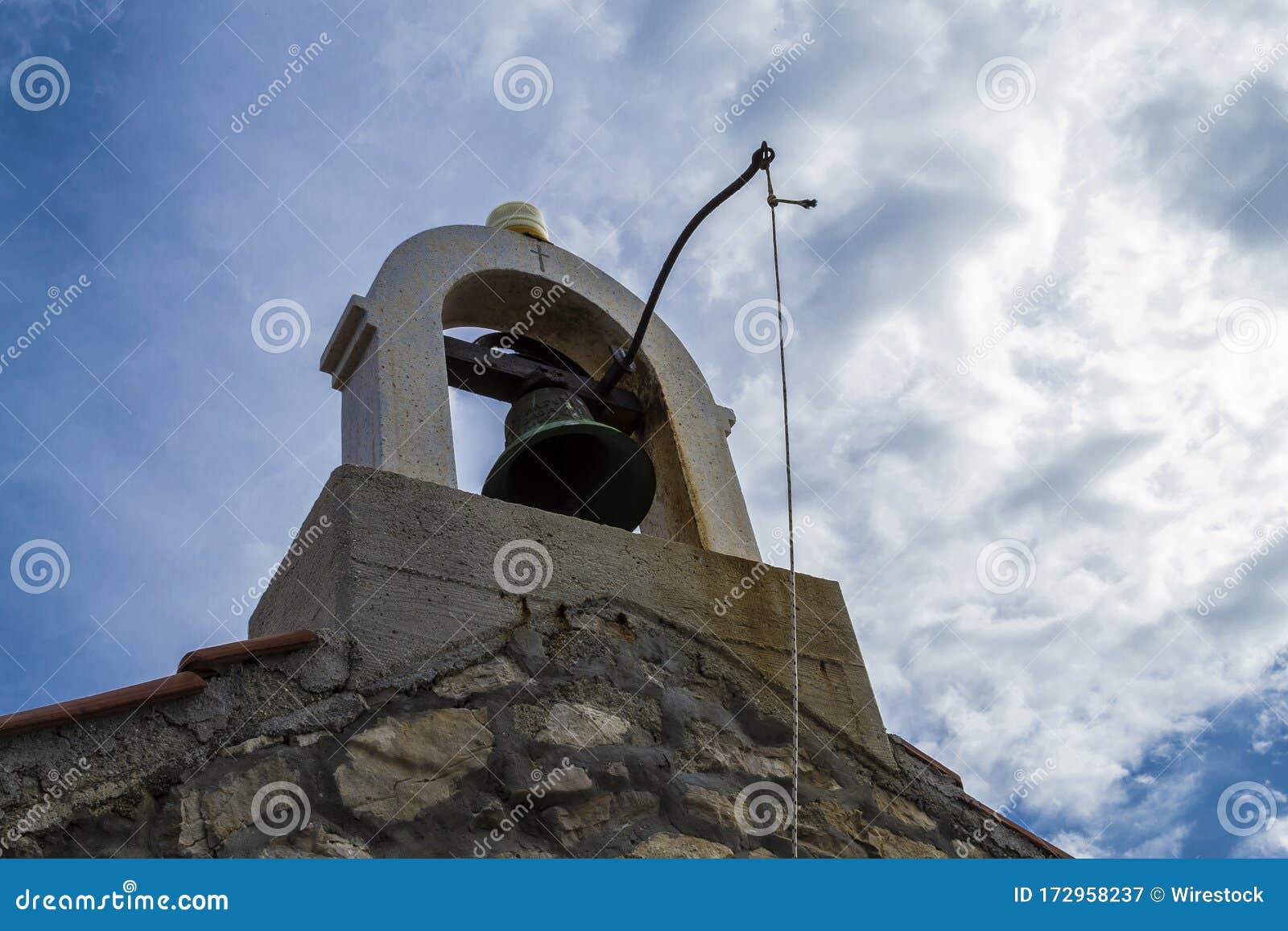 Low Angle Shot of a Small Bell Tower Under the Cloudy Sky Stock Image ...