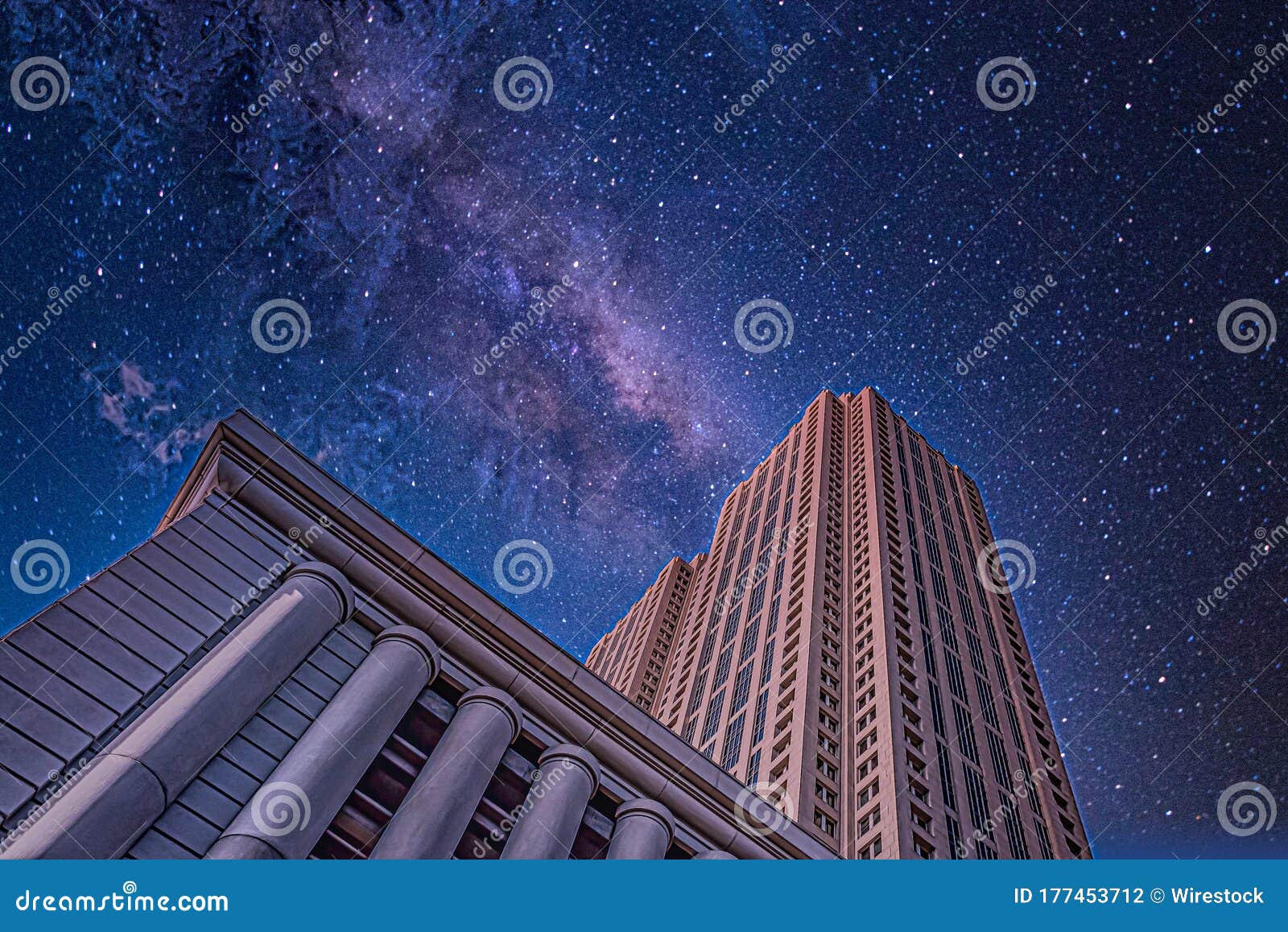 Low Angle Shot of Tall Buildings Under a Starry Night Sky Stock Photo ...