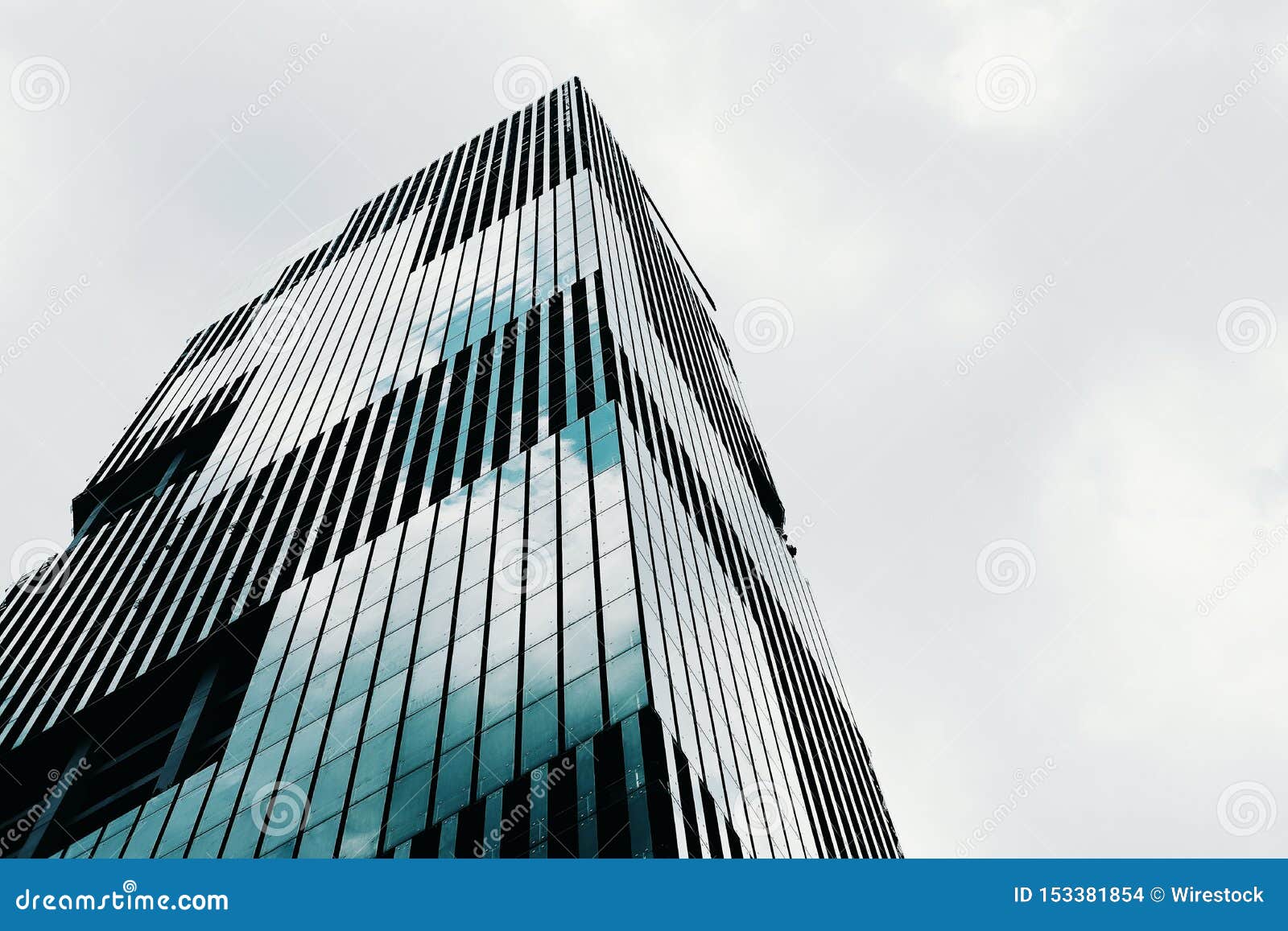 Low Angle Shot of a Tall High-rise Modern Business Building with a ... Low Angle Shot of a Tall High-rise Modern Business Building with a ...
