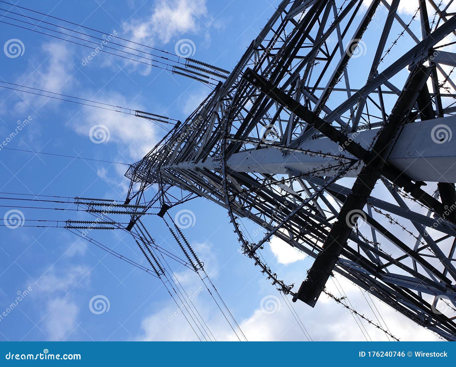 Low Angle Shot of Transmission Power Post Against a Cloudy Blue Sky ...