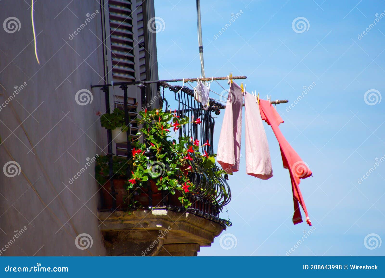 Low Angle Shot of Tropical Colored Balcony with Laundry Hanging on a ...