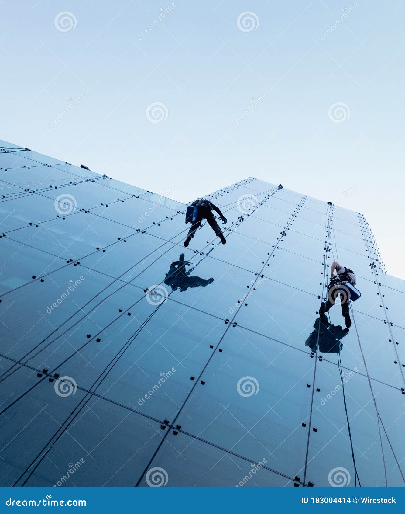 Low Angle Shot of Two Persons Rappelling at the Side of a Tall Building ...