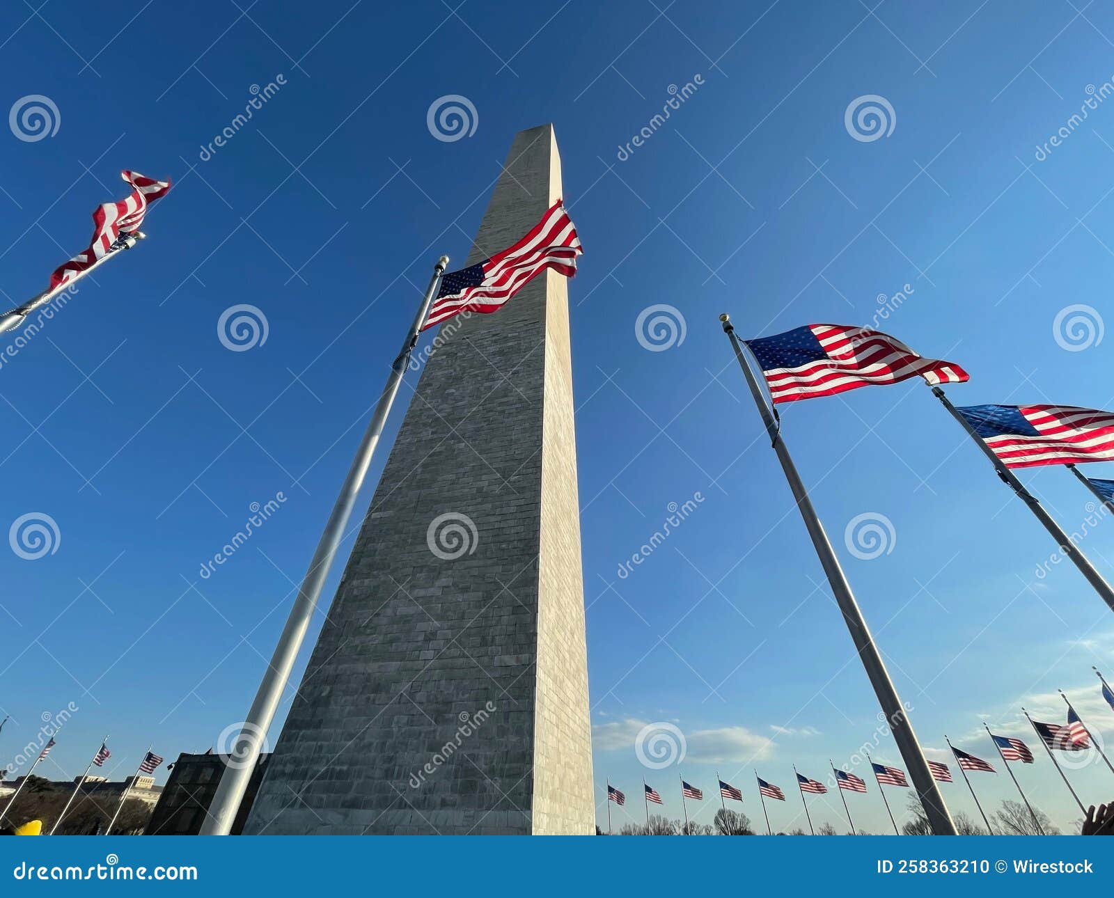 Low Angle Shot of the Washington Monument Surrounded by US Flags Under ...
