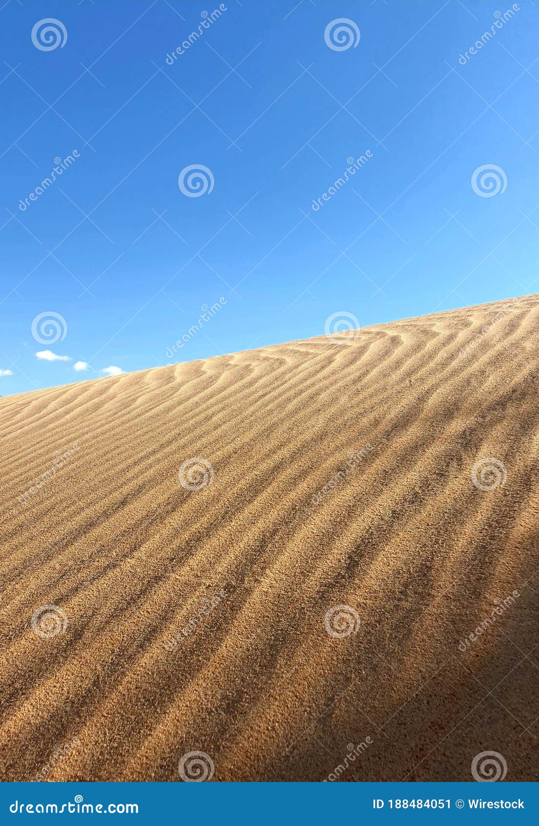 Low Angle Vertical Shot of a Sand Dune in a Desert Under the Blue Sky ...