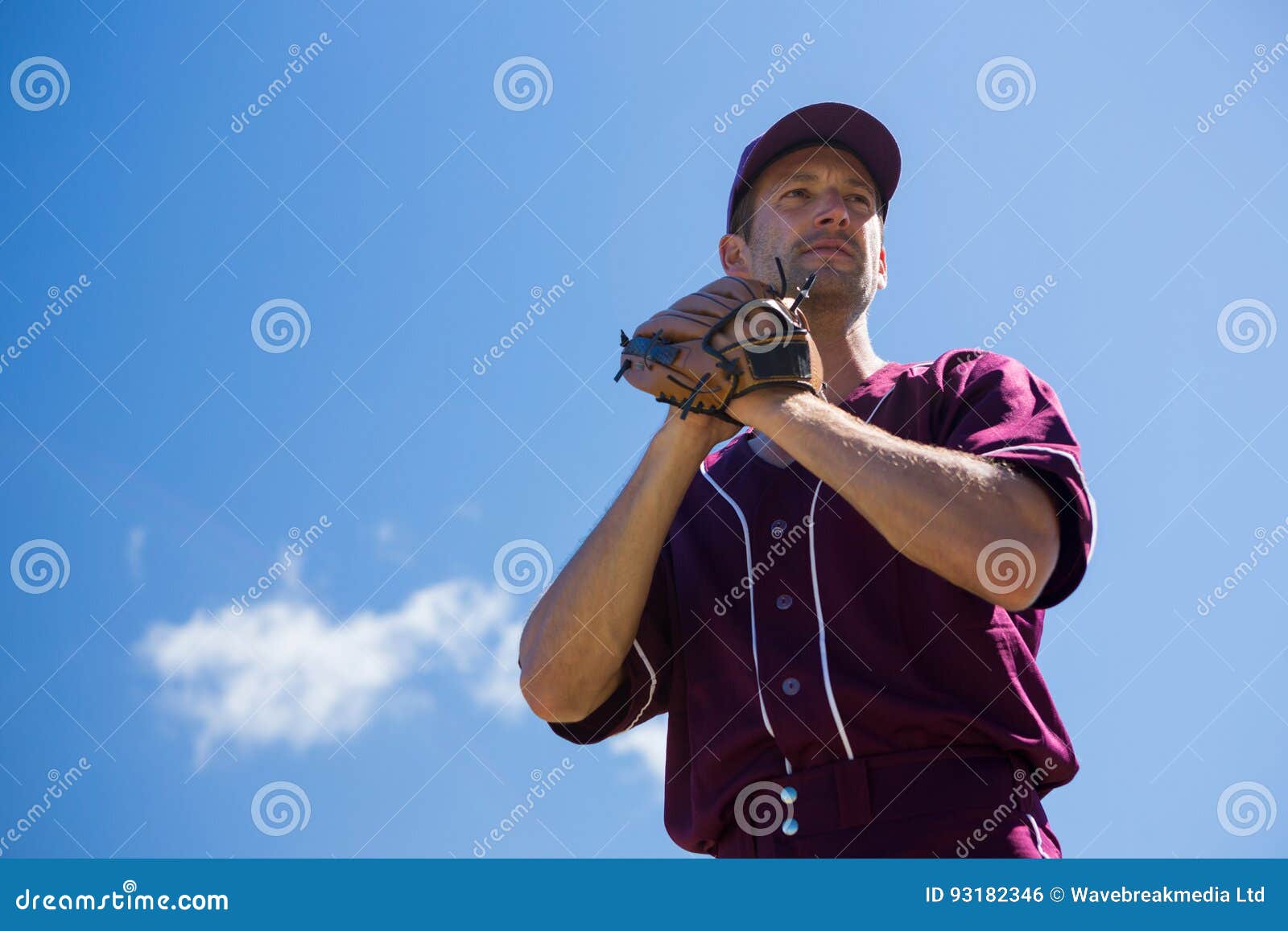 Low Angle View of Baseball Pitcher Standing Against Blue Sky Stock ...