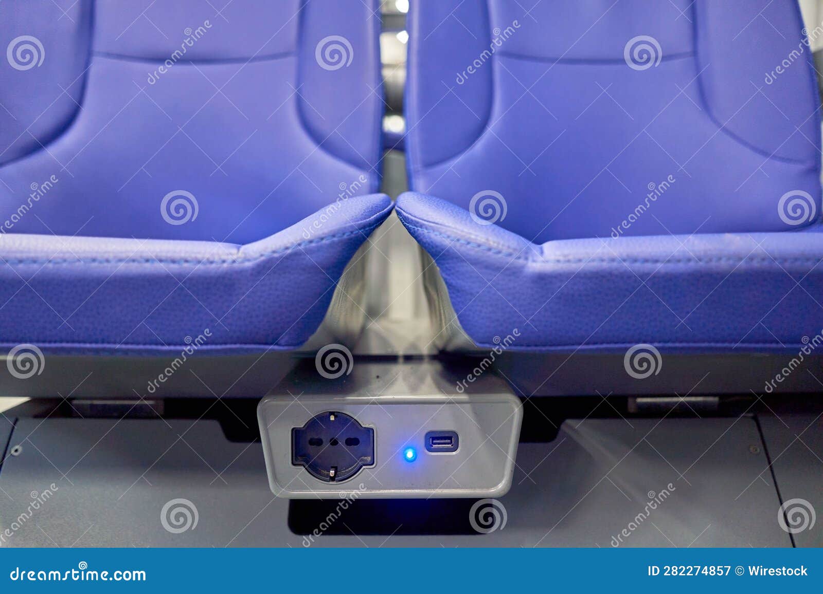 Low-angle View of Blue Train Seats Complete with Charging Ports for ...