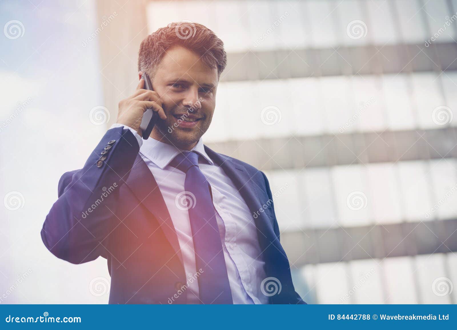 Low Angle View of Businessman Speaking on Mobile Phone Stock Photo ...