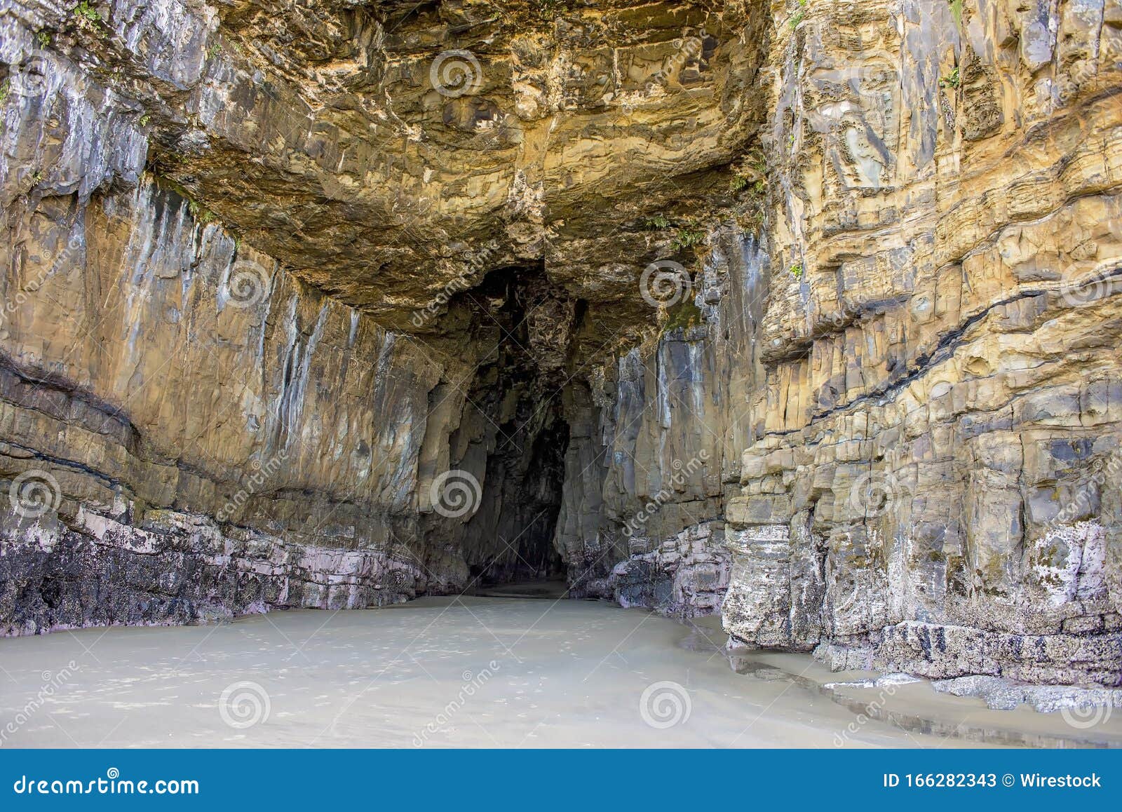 Low Angle View of a Cave with High Rocky Walls Surrounded by Water ...
