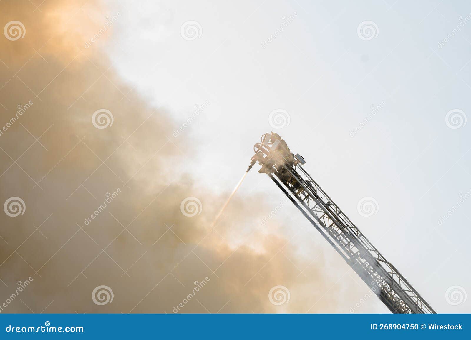 A Firefighter Extinguishing A Burning Car After An Accident. Top View ...