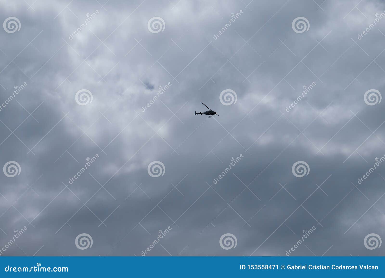 Low Angle View of a Flying Helicopter with Cloudy Sky As Background ...