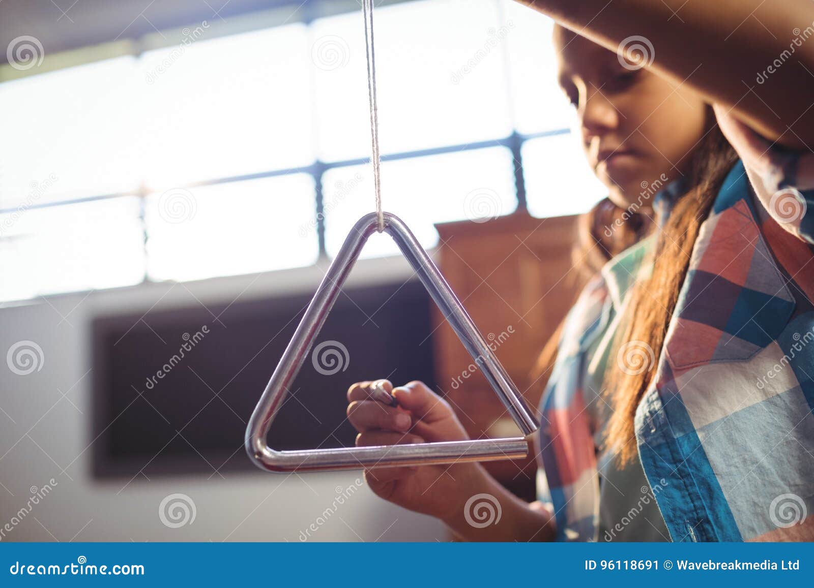 Low Angle View of Girl Playing Triangle Stock Image - Image of hair ...
