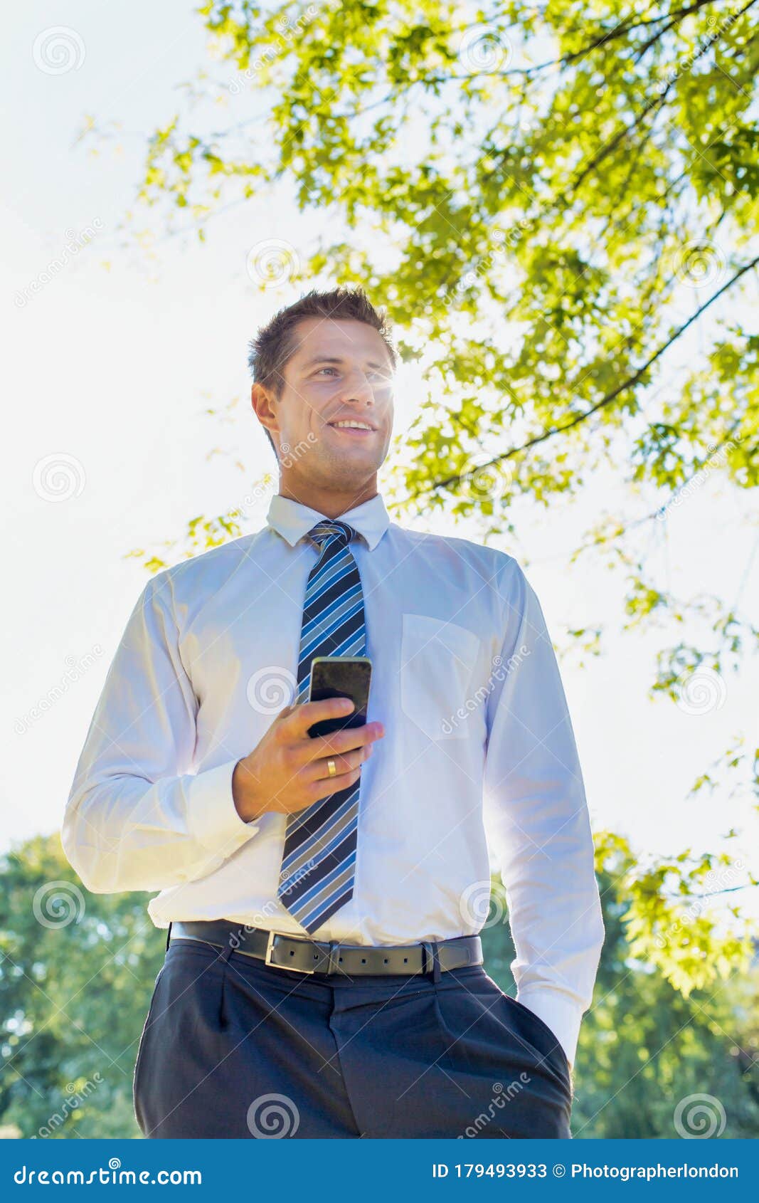Low Angle View of Handsome Mature Businessman Using Smartphone Stock ...