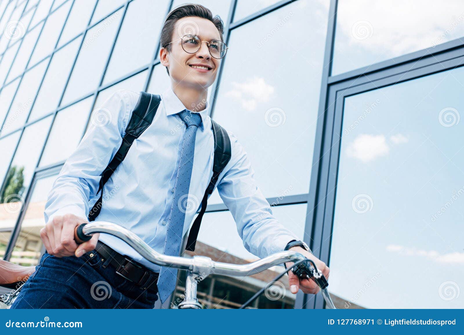 Low Angle View of Handsome Smiling Young Businessman Stock Image ... Low Angle View of Handsome Smiling Young Businessman Stock Image ...