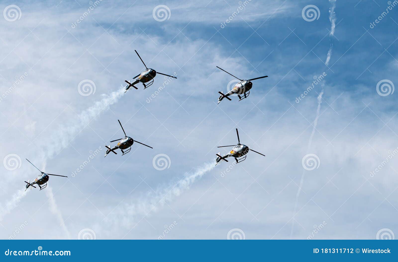 Low Angle View of Helicopters Flying Under a Cloudy Sky and Sunlight at ...