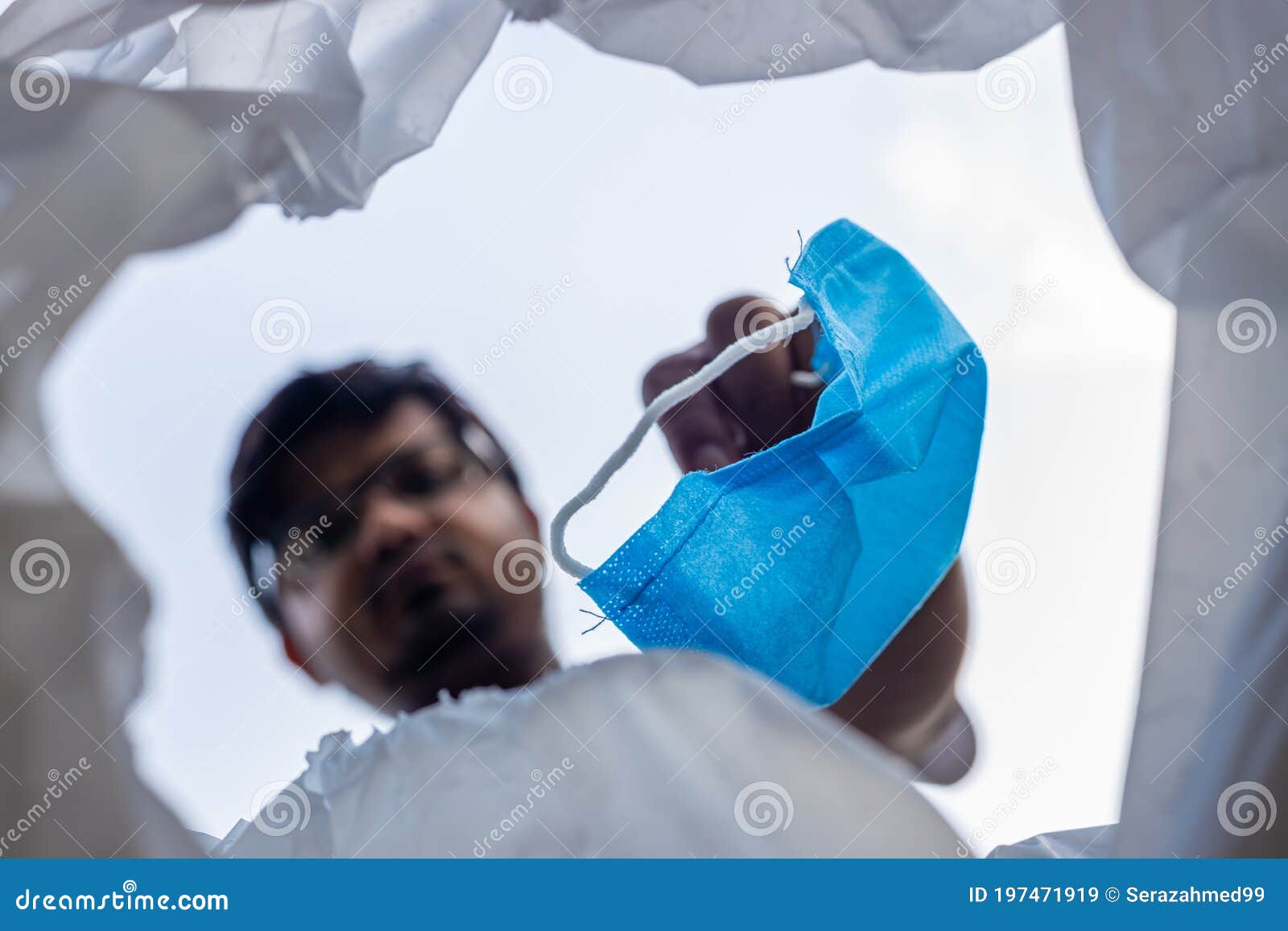 Low Angle View of a Man Throwing Disposable Surgical Mask into the Bin ...