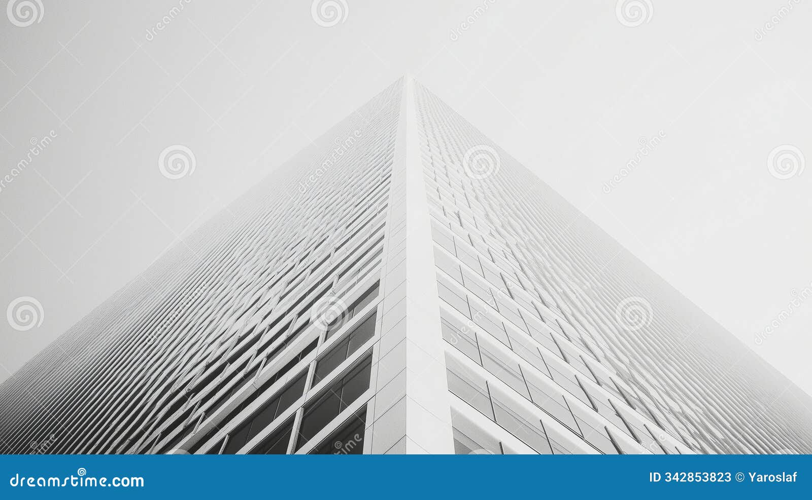 Low Angle View of Modern Building Soaring into Cloudy Sky, Showcasing ...