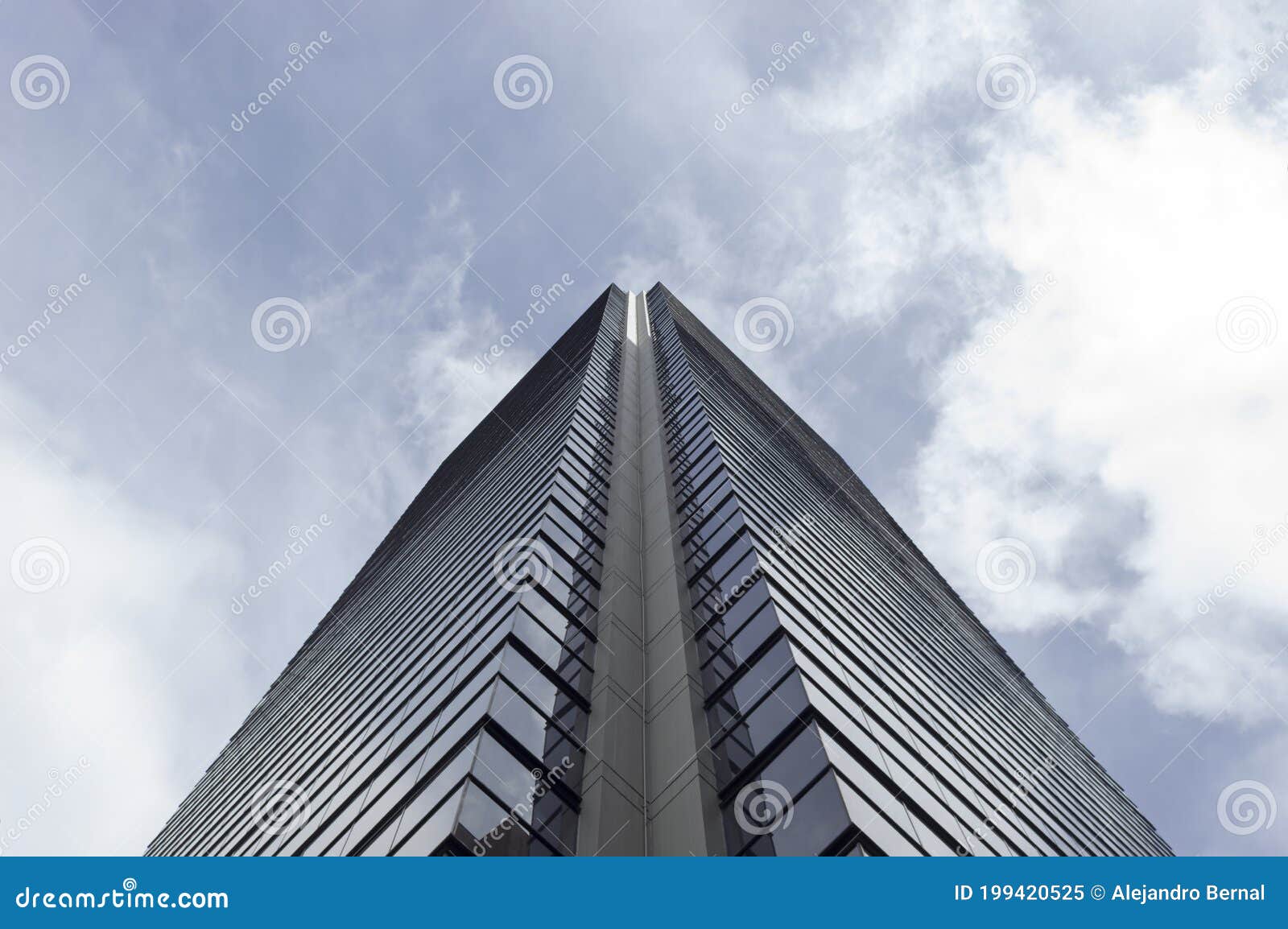 Low Angle View of a Modern Skyscraper Corner with Cloudy Sky at ...
