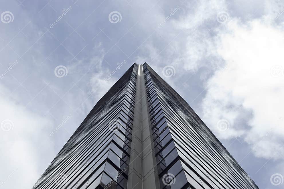 Low Angle View of a Modern Skyscraper Corner with Cloudy Sky at ...