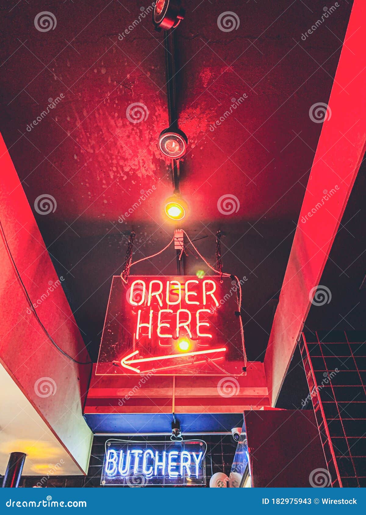 Low Angle View of Neon ORDER HERE Sign and Arrow Pointing Left Stock ...