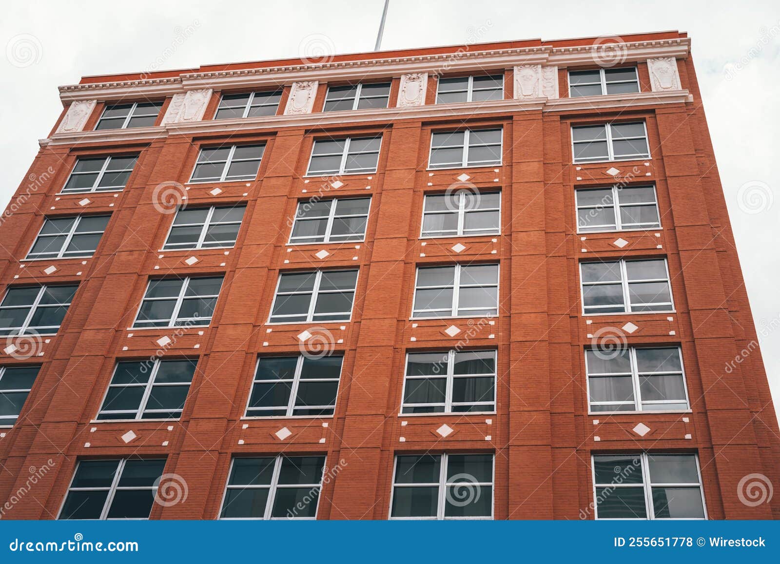 Low-angle View of an Orange Colored Building Facade with Square Windows ...