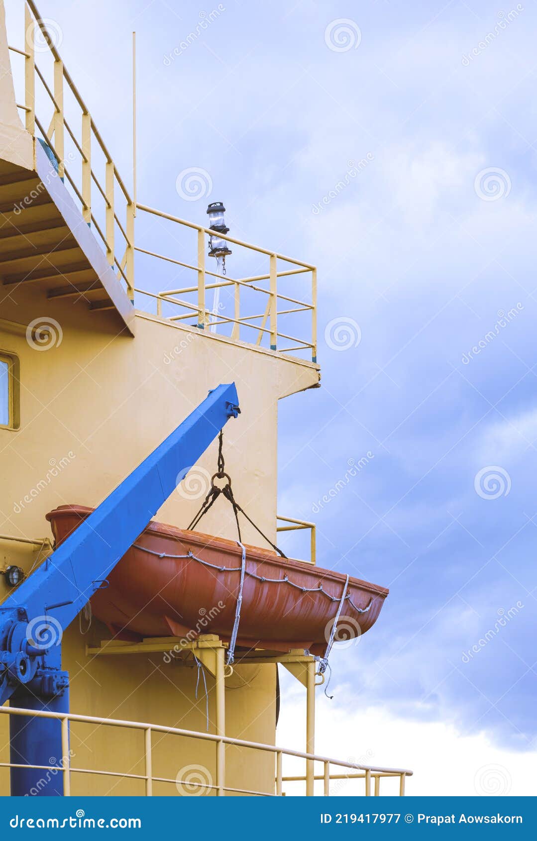 Low Angle View of Orange Lifeboat and Crane Boom on Deck of Cargo Ship ...